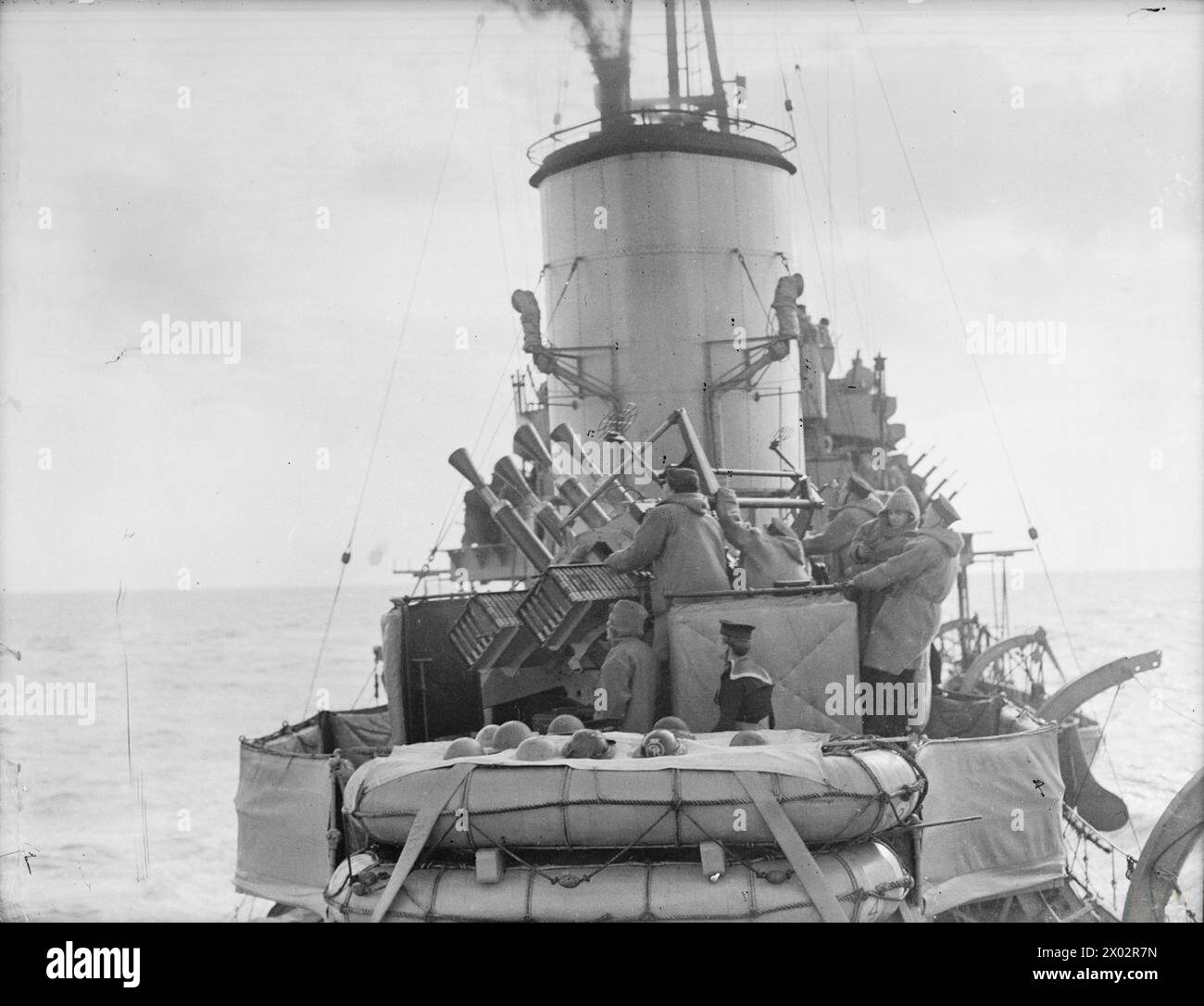 Pom-pom guns are being operated aboard HMS Kelvin at sea with the fleet ...
