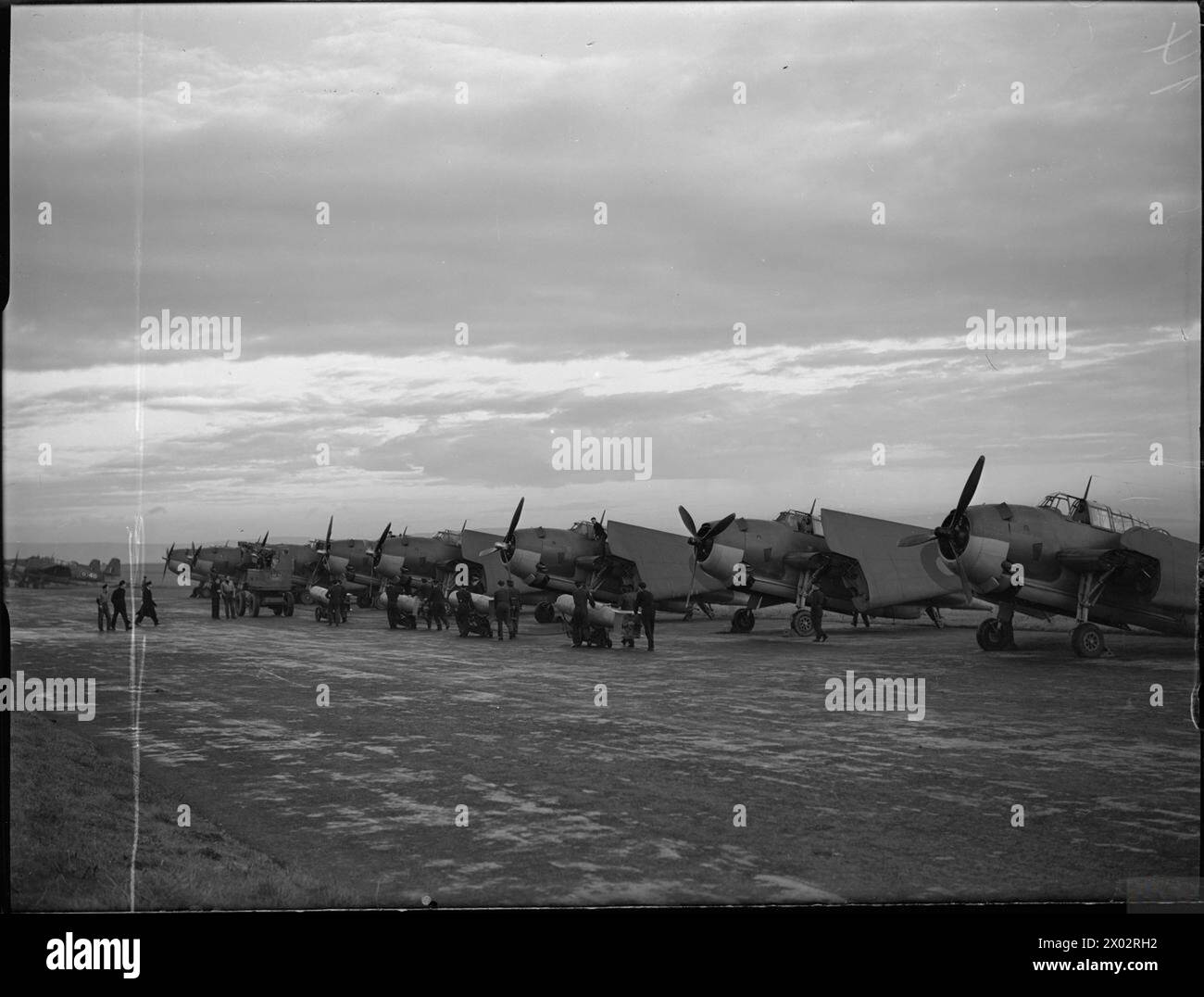 Eight American-built Grumman Avenger torpedo bombers are loaded with ...