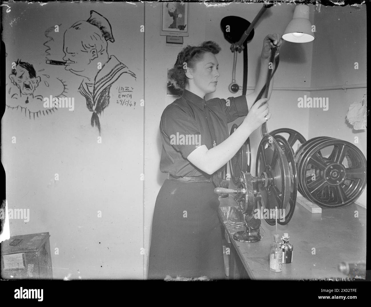 Wren B. Brocklies checks film in the re-wind room of the Dockyard ...