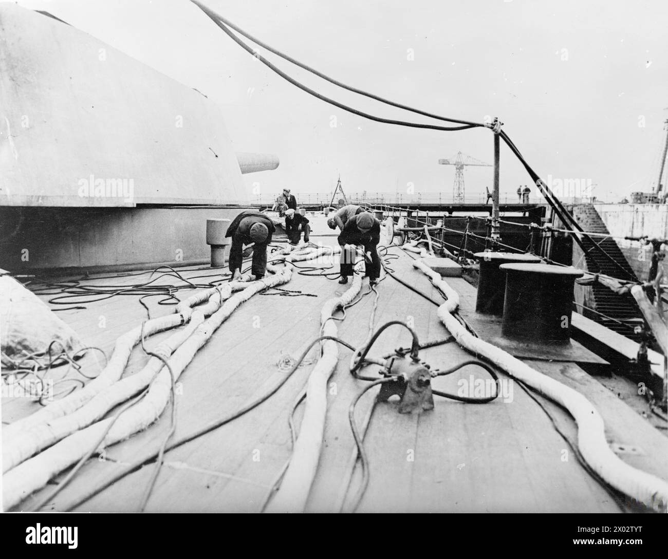 Workmen install and maintain degaussing cables aboard HMS Repulse ...