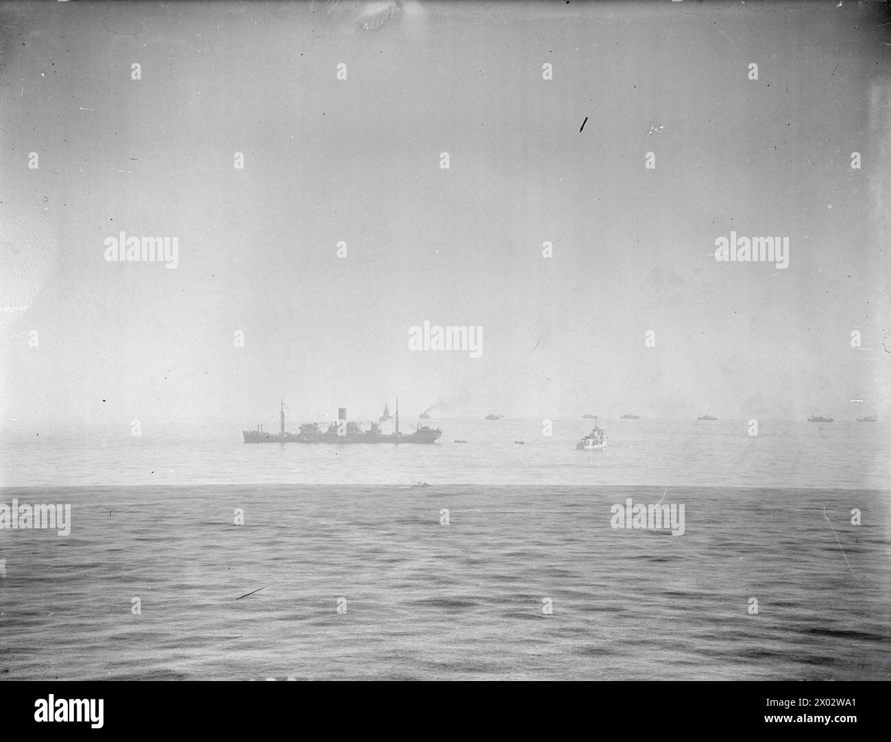 A CONVOY TO MALTA. 5-13 AUGUST 1942. - A destroyer standing by SS ...