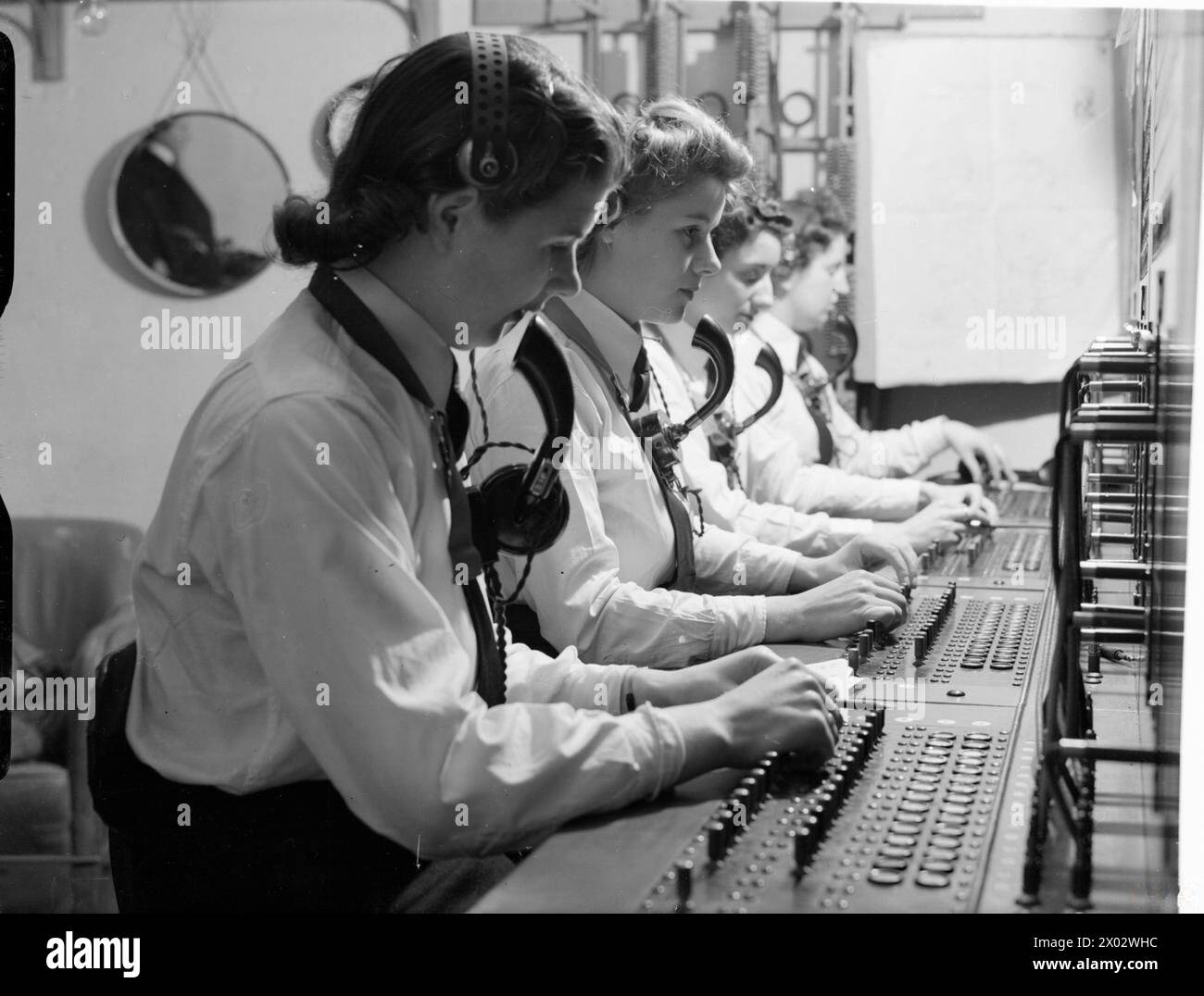Wrens of the Women's Royal Naval Service operate the naval exchange at ...