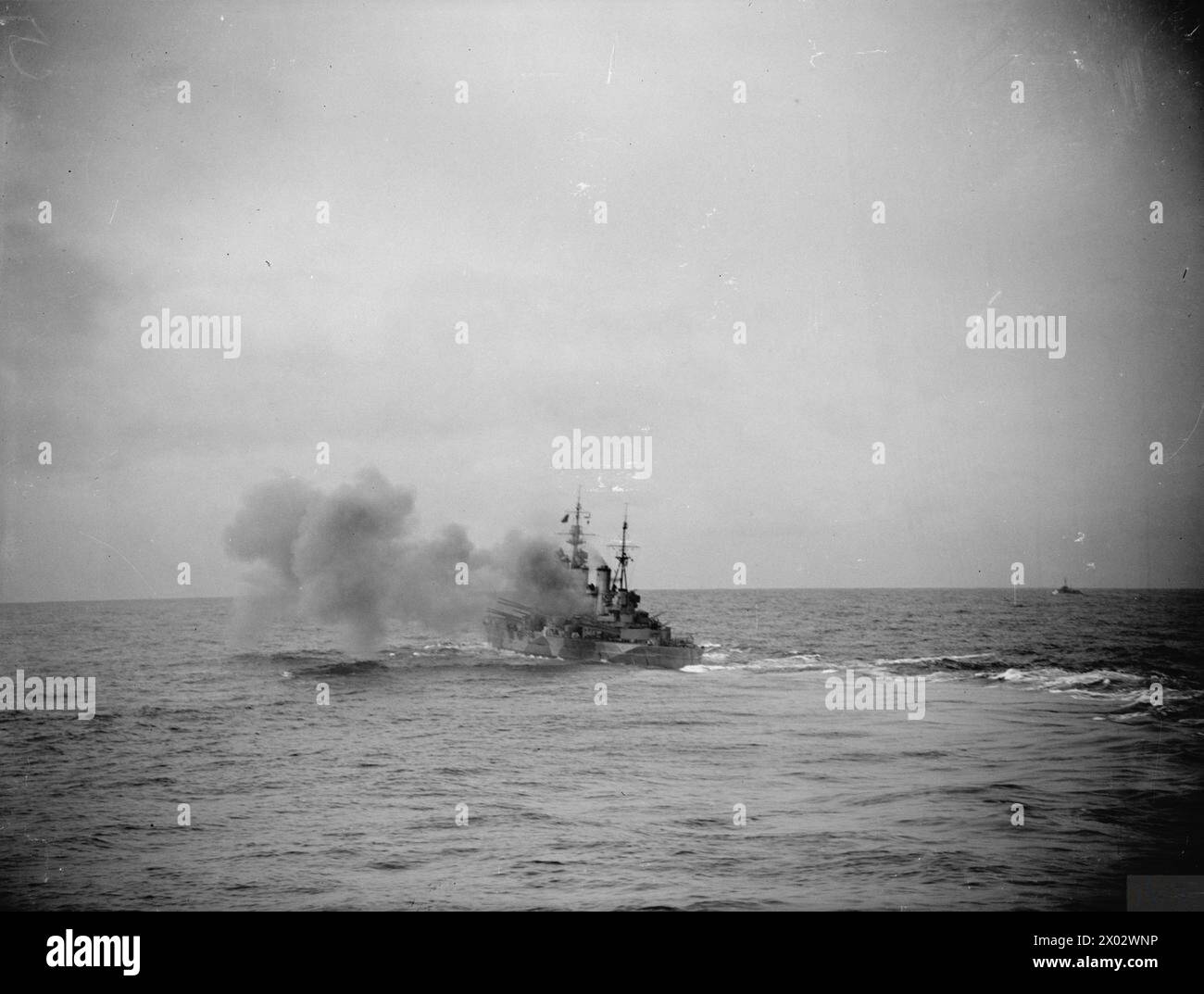 HMS HOWE AND HMS KING GEORGE V. SCAPA FLOW, 17 OCTOBER 1942. - A view of HMS HOWE firing her 14 ...