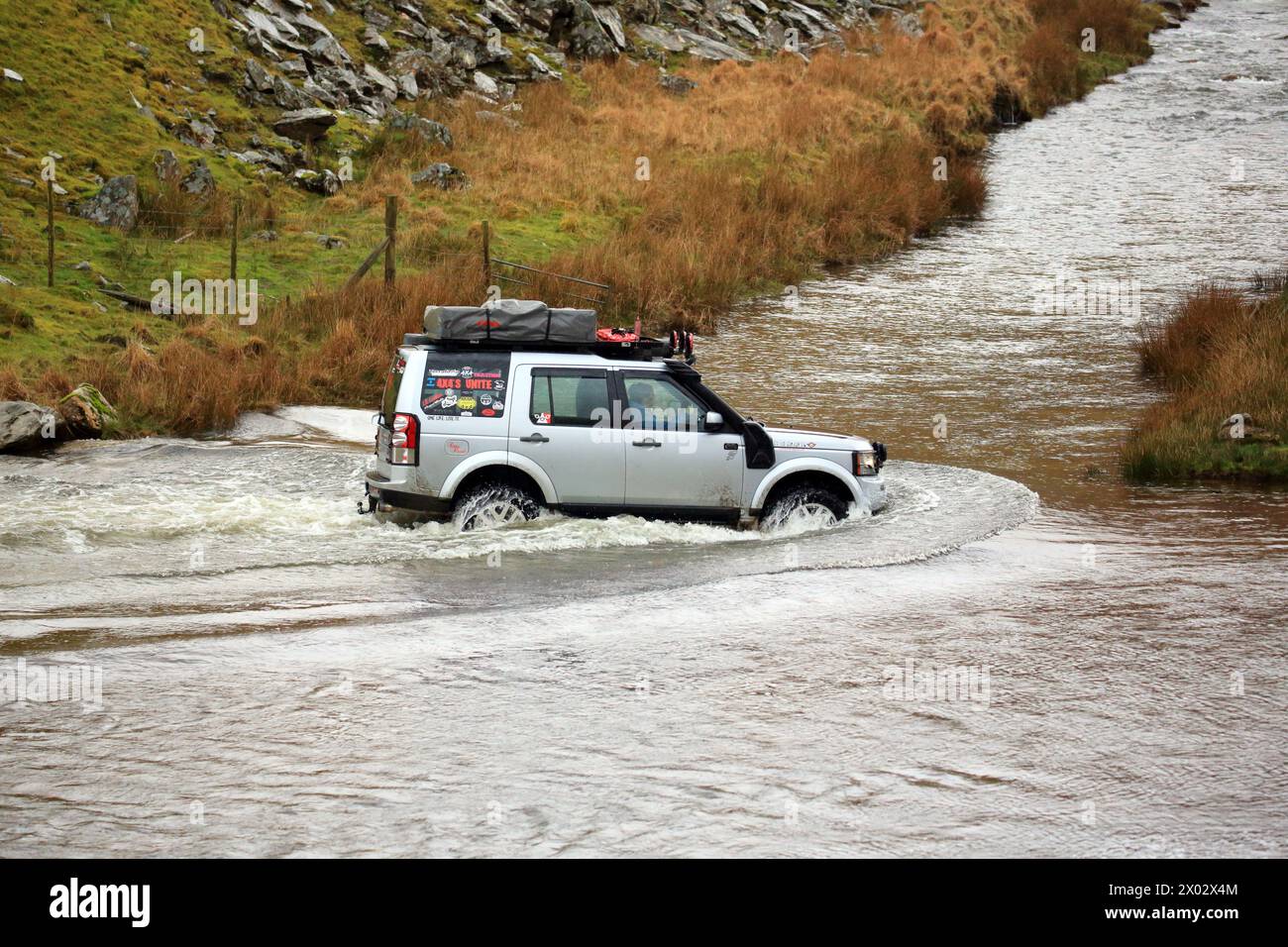 Land Rover crossing a river in the Elan valley, Powys, Wales, UK Stock ...