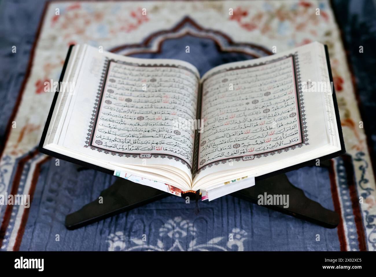 Open Quran in Arabic on wood stand, Symbol of Islam, Mubarak Mosque ...