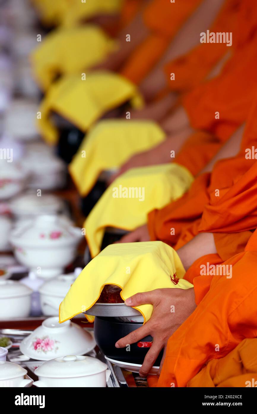 Vegetarian meal, monks at Buddhist ceremony in the main hall, Phuoc Hue ...