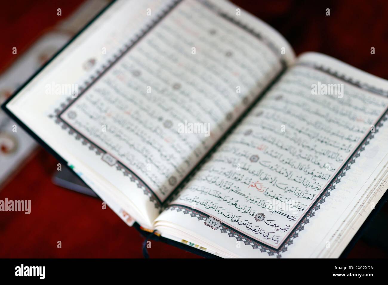 Open Quran in Arabic on wood stand, Symbol of Islam, Mubarak Mosque ...