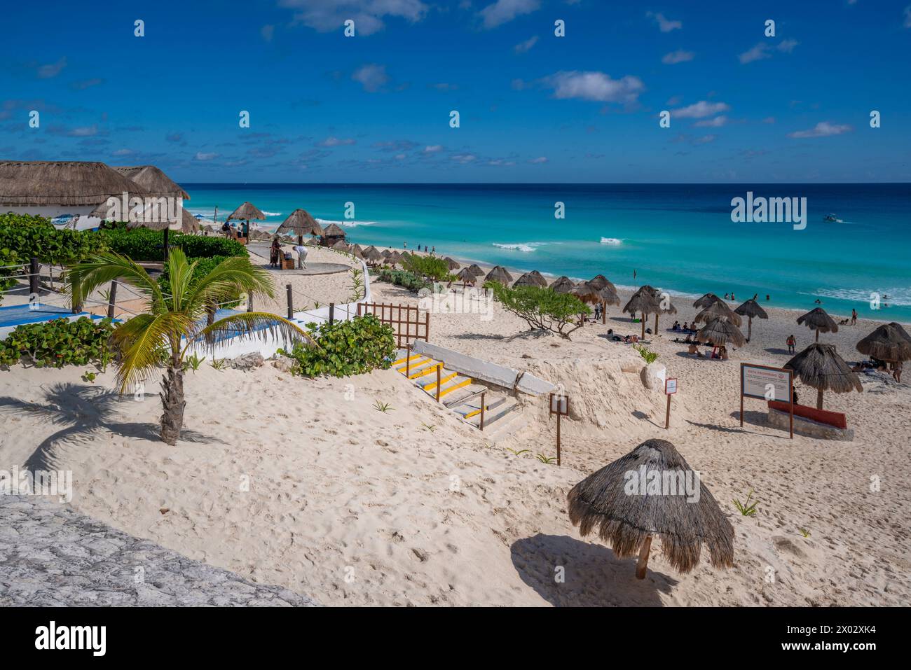 View of long white sandy beach at Playa Delfines, Hotel Zone, Cancun ...