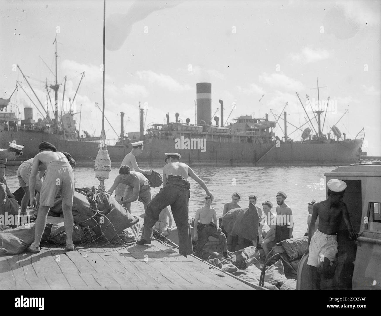 HMS CUMBERLAND DELIVERS THE MAIL. 26 OCTOBER 1945, COLOMBO, CEYLON. THE ...