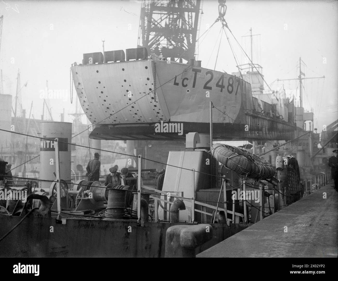 The giant crane 'Mammoth' lifts a 147-ton tank landing craft from the ...