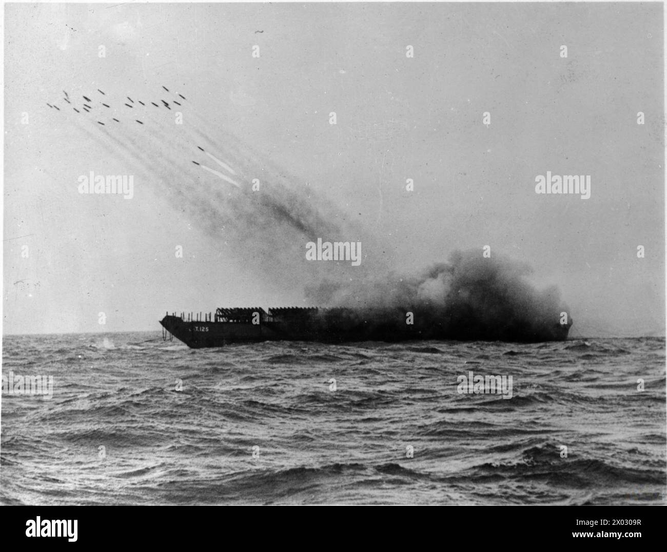 LC(R) T125, a Royal Navy landing craft, launched a salvo of rockets at ...