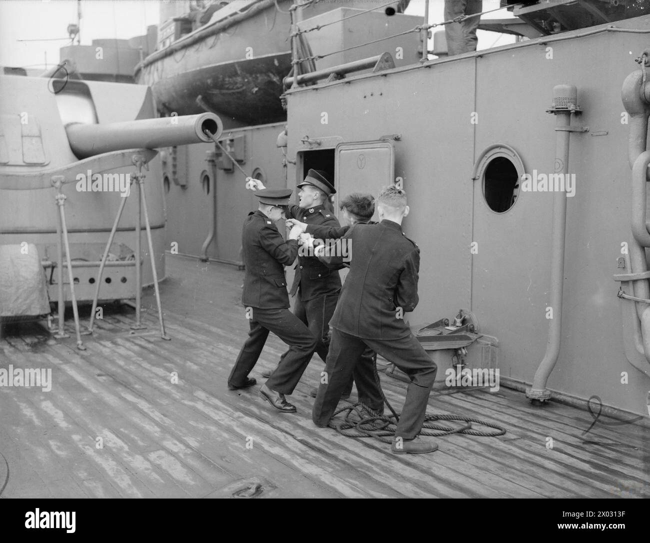ON BOARD HMS RODNEY. 1940, AT SEA, ON BOARD THE BATTLESHIP HMS RODNEY. - It takes four men to ...