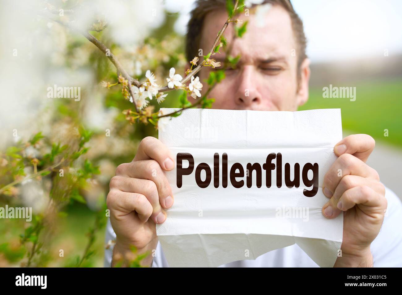 9 April 2024: man with a cold holding a handkerchief in front of a ...