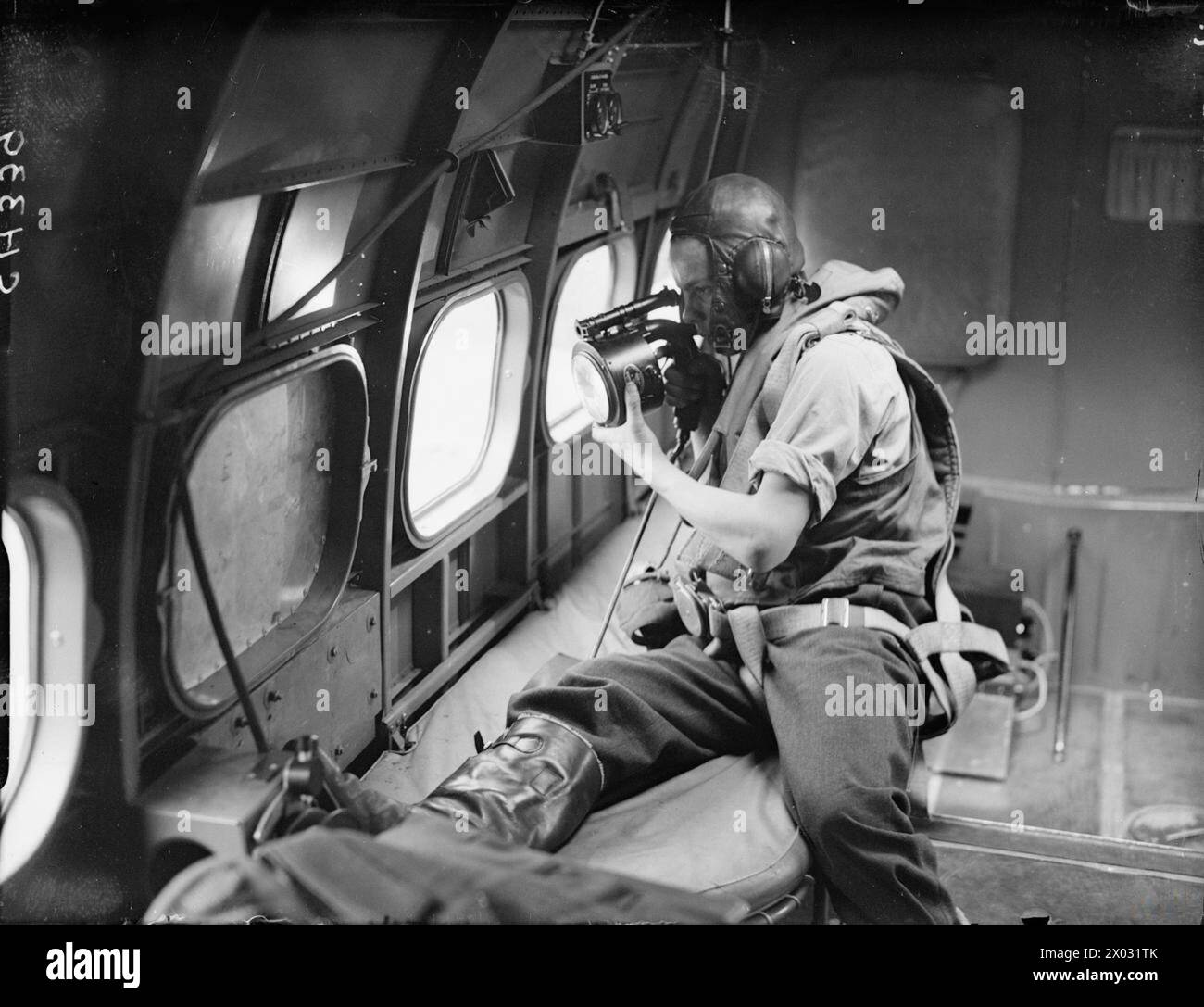 A wireless operator and air gunner of a Lockheed Hudson Mk I of No. 206 ...