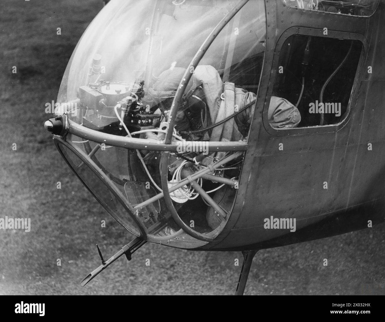 Navigator of a Handley Page Hampden bomber leans over the bombsight in ...