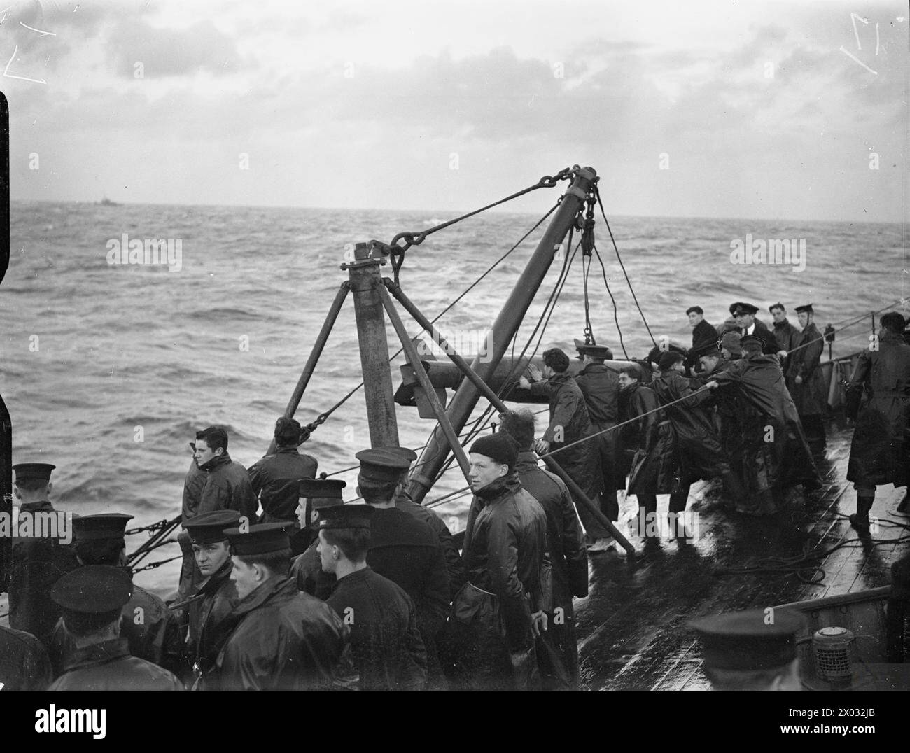 ON BOARD THE BATTLESHIP HMS RODNEY AT SEA. 1940. - "Paravanes out!" is ...