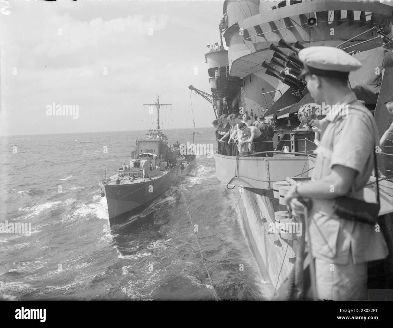 DESTROYER OILING FROM HMS ILLUSTRIOUS AT SEA. 18 OCTOBER 1942, ON BOARD ...