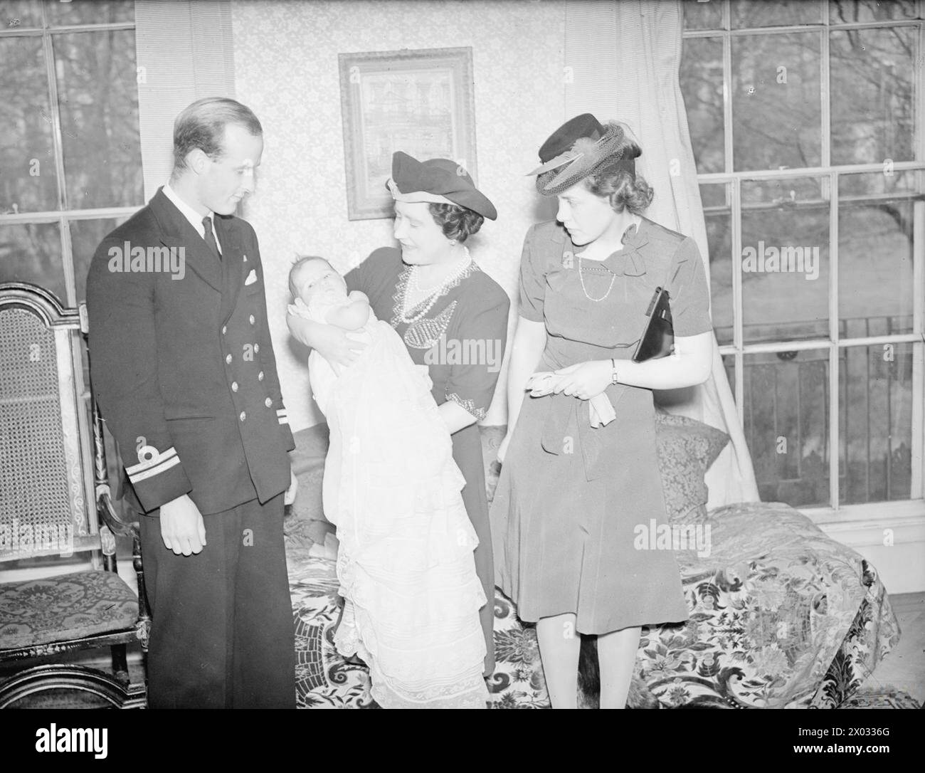 The Queen is shown holding her goddaughter Elizabeth, three months old ...