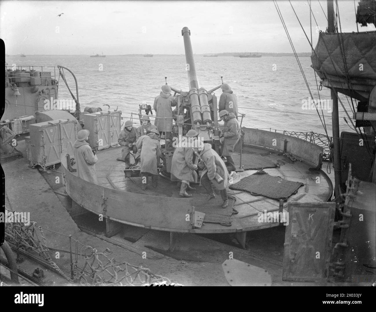 Polish Navy personnel conduct gun drill on a QF 4-inch Mk V anti-aircraft gun aboard the ...
