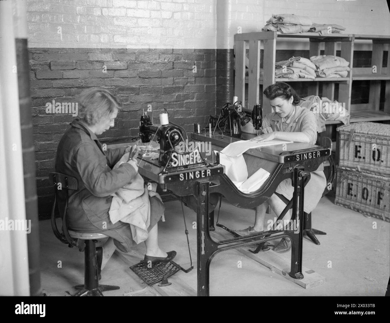 WAR INDUSTRY: WORKERS' WELFARE, UK, 1941 - Women use sewing machines to ...