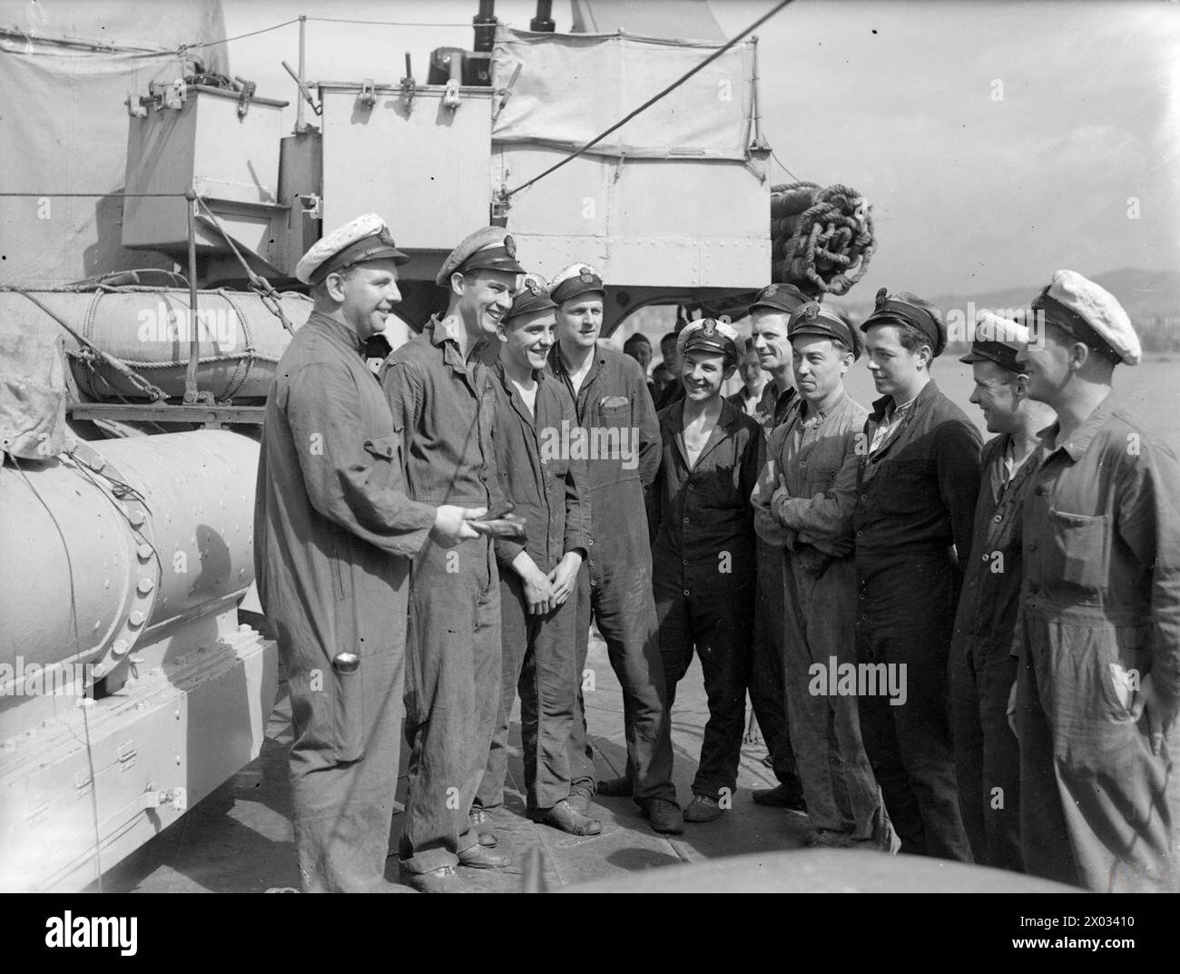 In May 1945 at Cannes, the engine room staff of HMS Lookout are shown ...