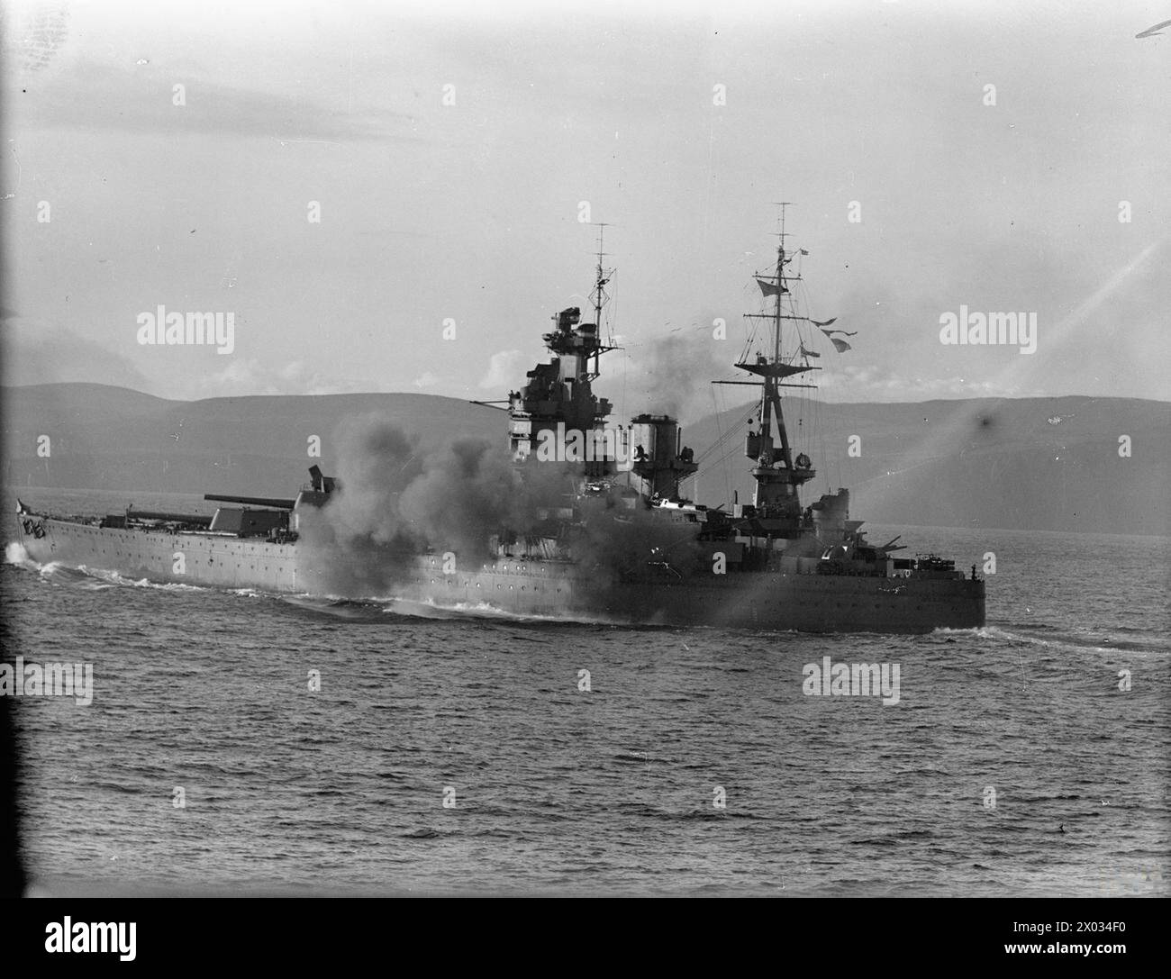 ON BOARD THE BATTLESHIP HMS RODNEY AT SEA. 1940. - HMS NELSON firing ...