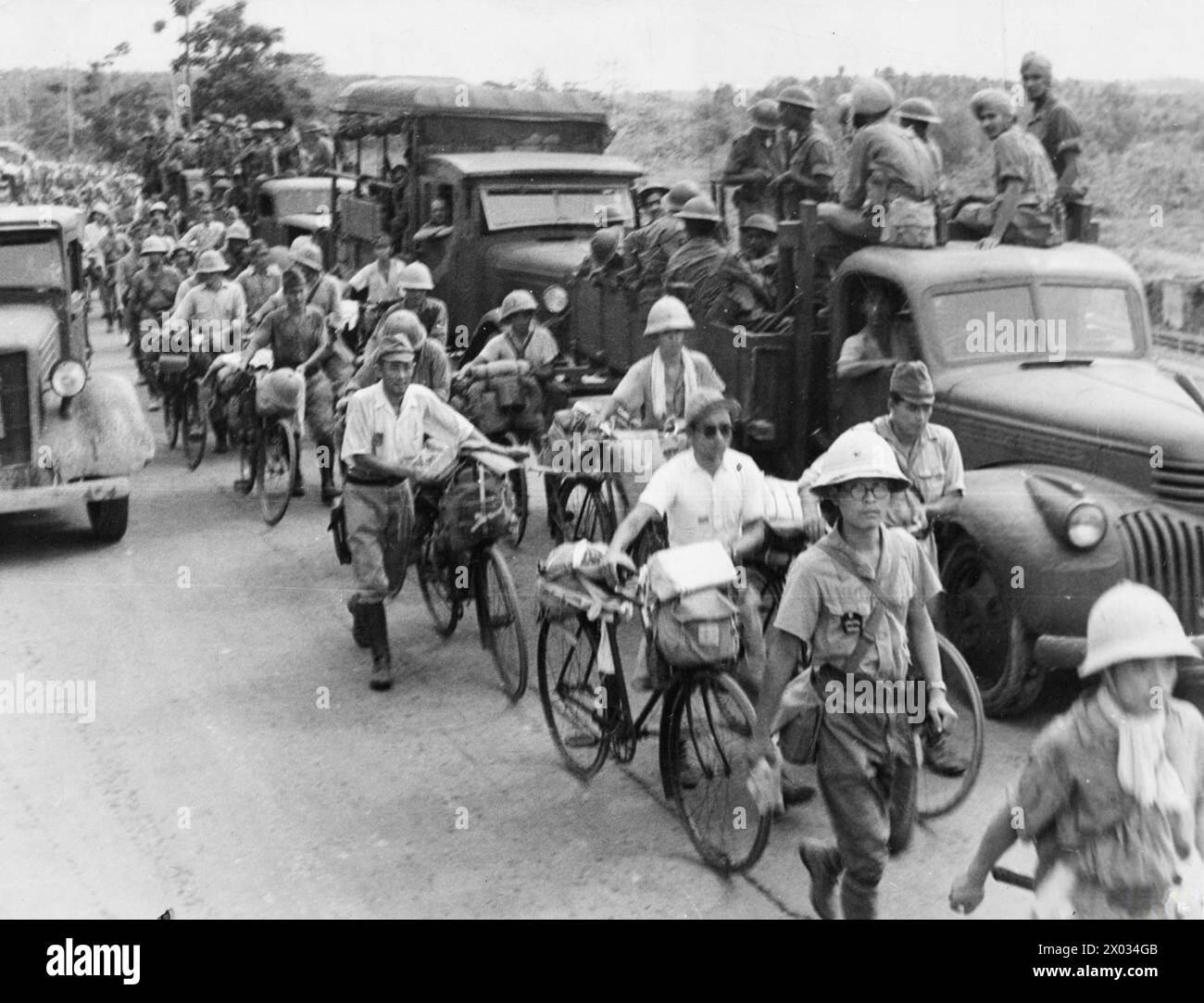Soldiers of the 5th Indian Division observe disarmed Japanese troops ...