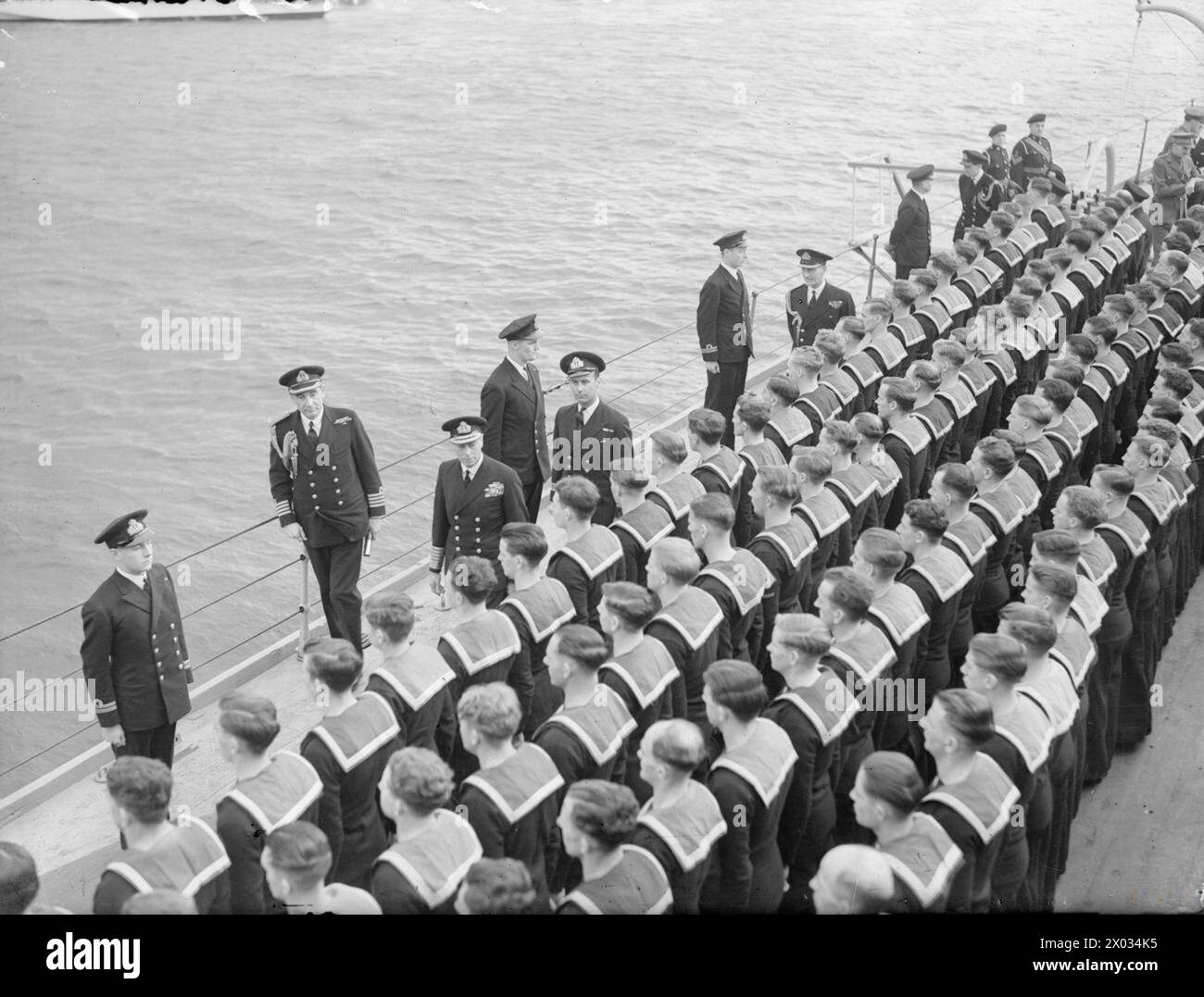 King George VI inspected divisions aboard the battleship HMS Ramillies ...