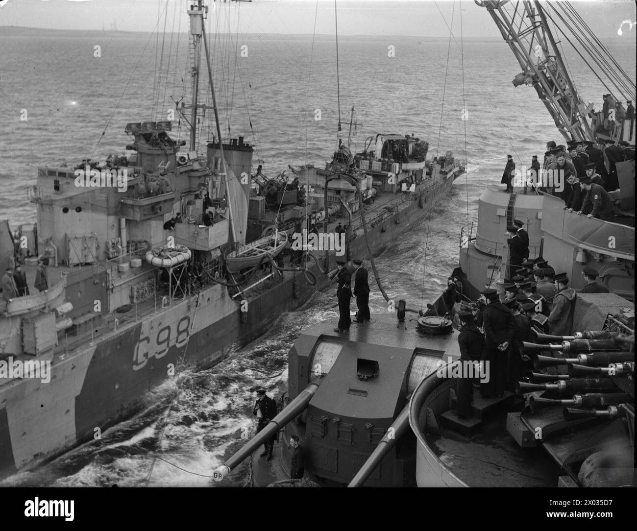 NAVY OPERATION: BRITISH BATTLESHIP REFUELS DESTROYER AT SEA. 6 FEBRUARY ...