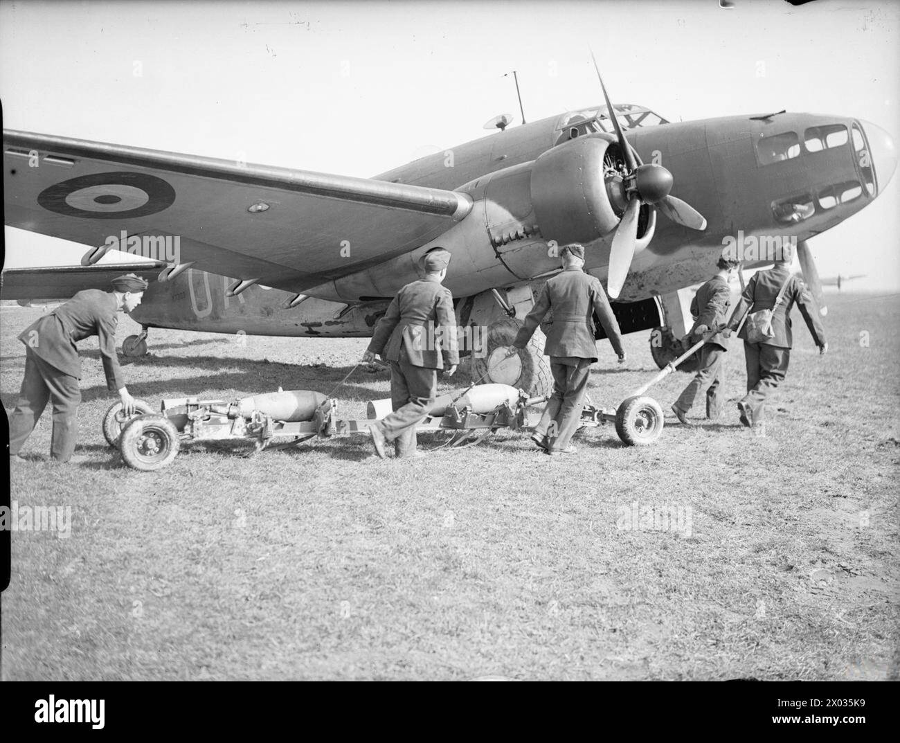 In April 1940 at Wick, Scotland, armourers move trolleys with 250-lb GP ...