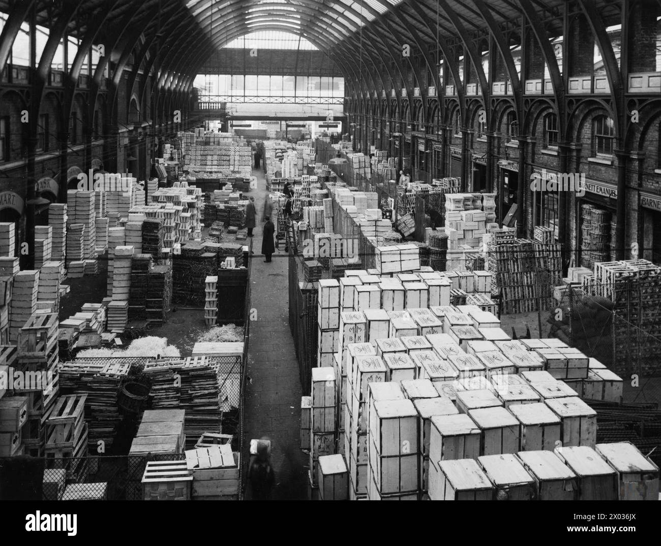 In 1940, traders in the vaulted market hall at Covent Garden, London ...