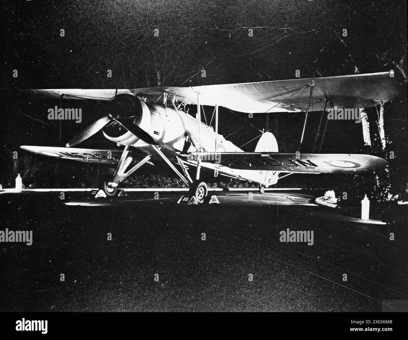A Fairey Swordfish aircraft is on the ground at night, representing the ...