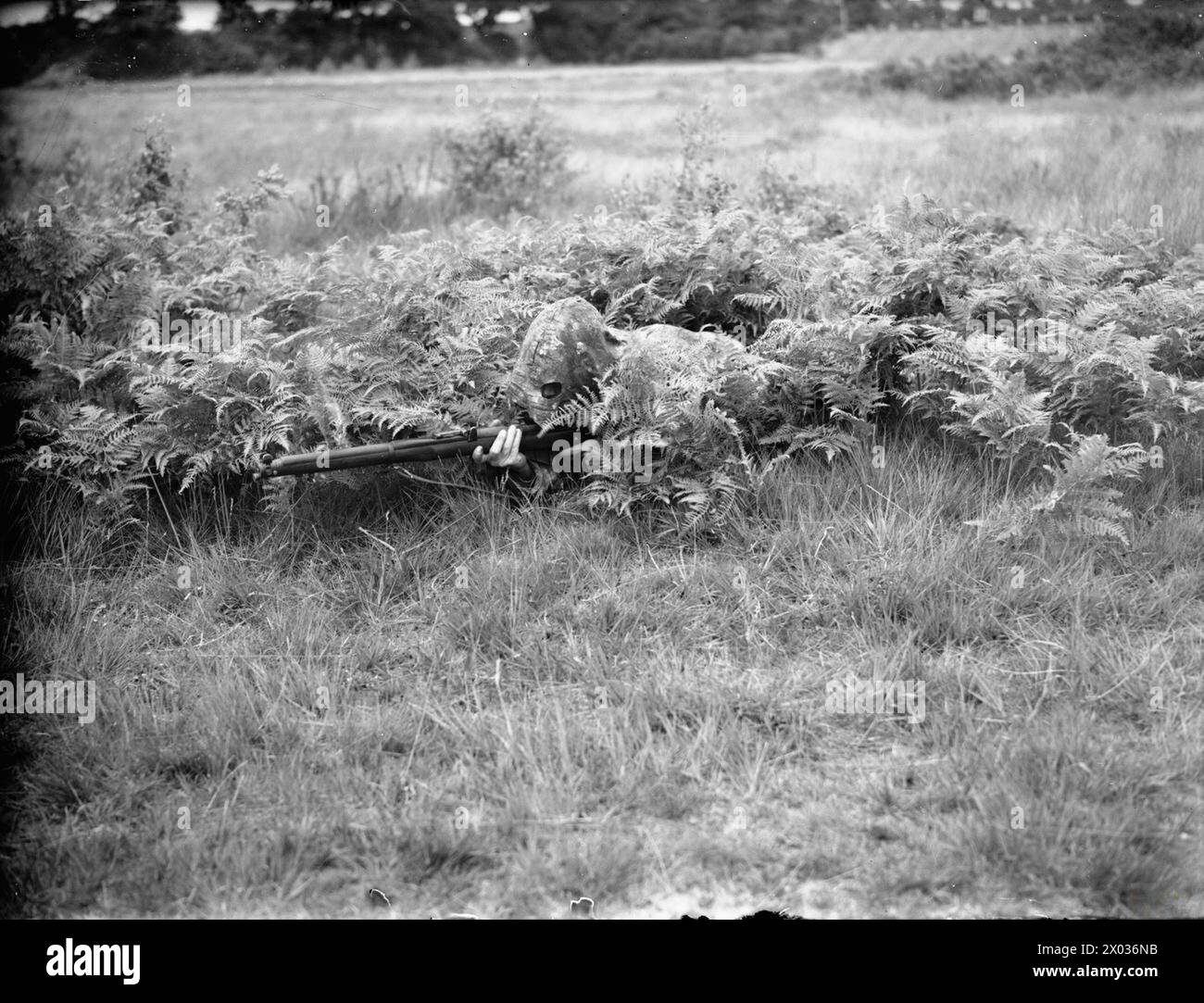 A Lovat Scout of the British Army in a prone firing position wearing a ...