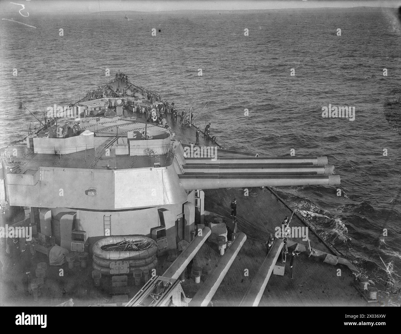 In 1940 aboard HMS Rodney, crew on the forecastle prepared to enter ...