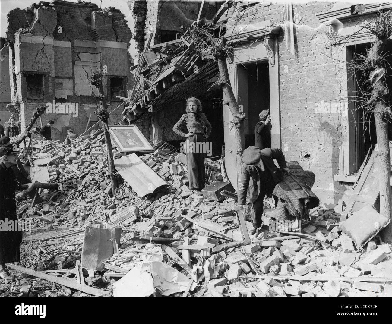 BOMB DAMAGE: SALVAGE, 1943 - Eva Barker (King) outside her damaged ...