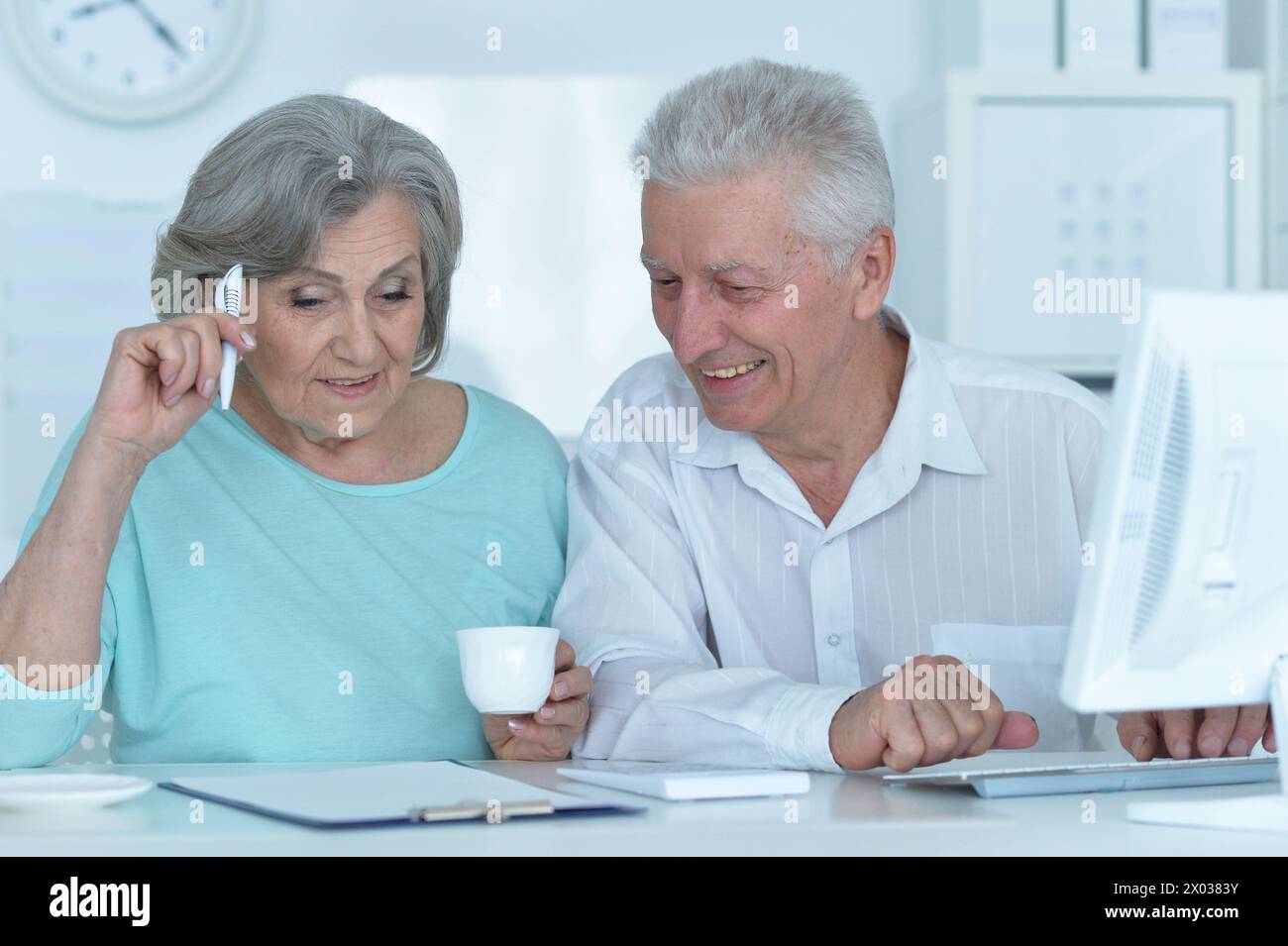 portrait of two old people working with a laptop in the office Stock ...