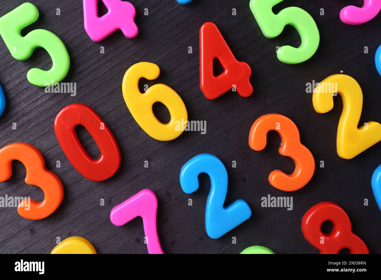 Colorful numbers on dark wooden school desk, flat lay Stock Photo - Alamy
