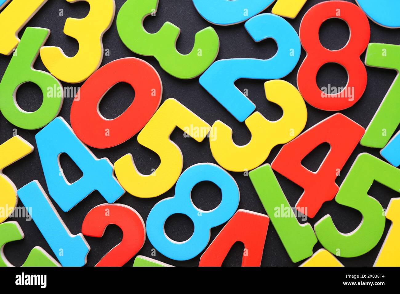 Colorful numbers on black background, top view Stock Photo - Alamy