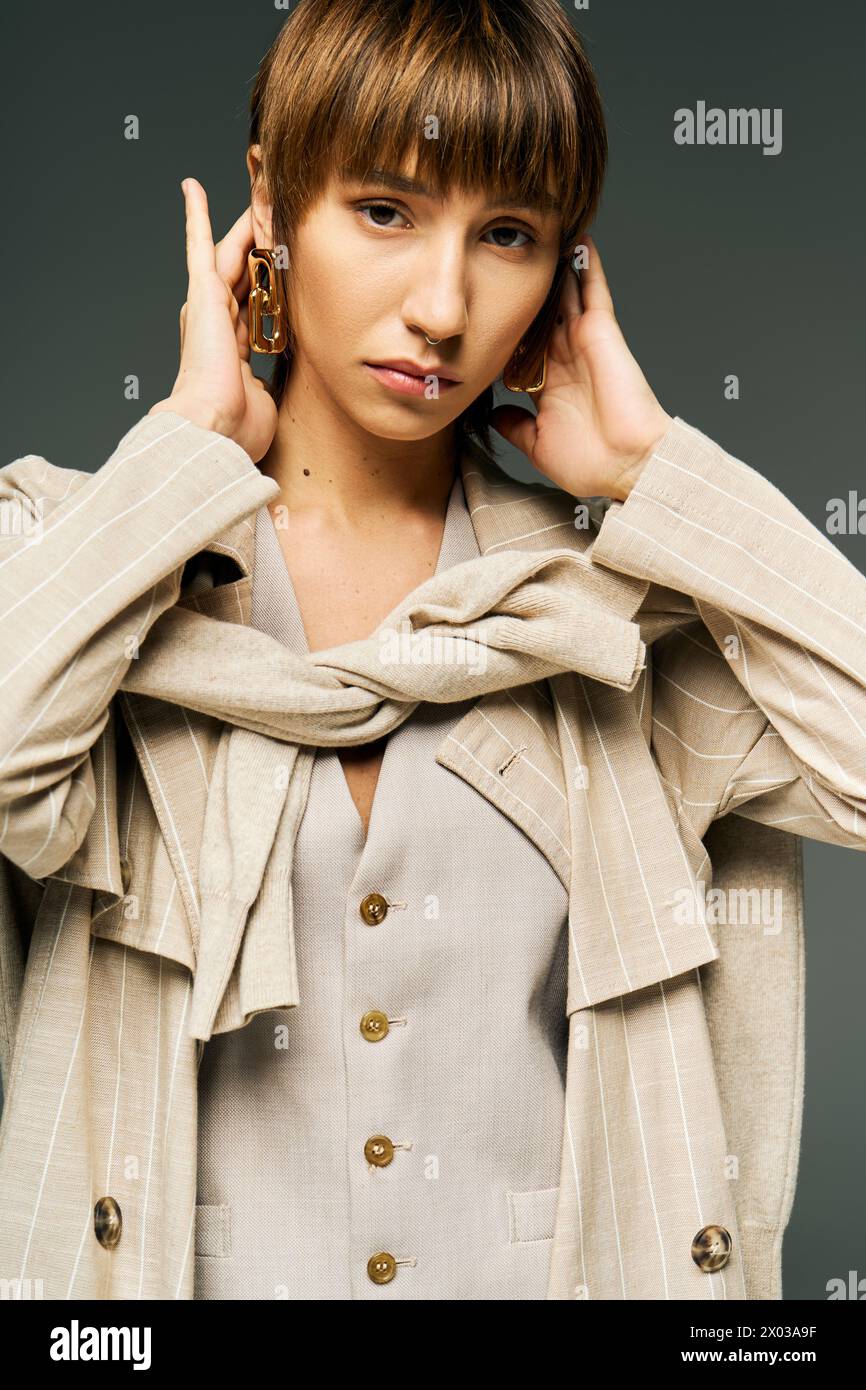 A young woman in a studio setting wearing a stylish scarf around her ...