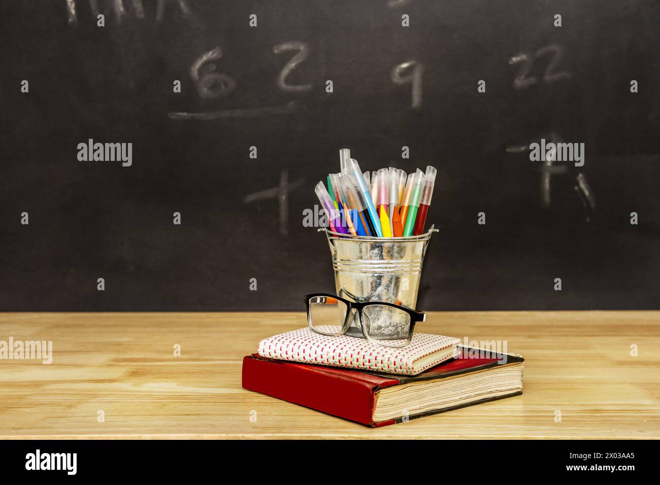 book and notebook and a cube with markers on top Stock Photo - Alamy