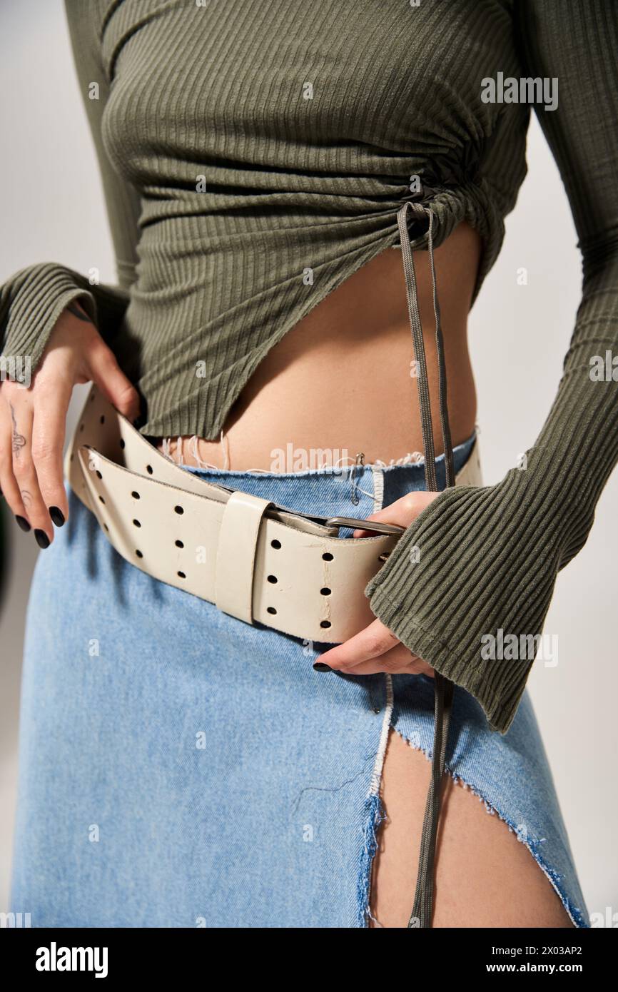 A young woman with brunette hair dancing energetically showing belt ...