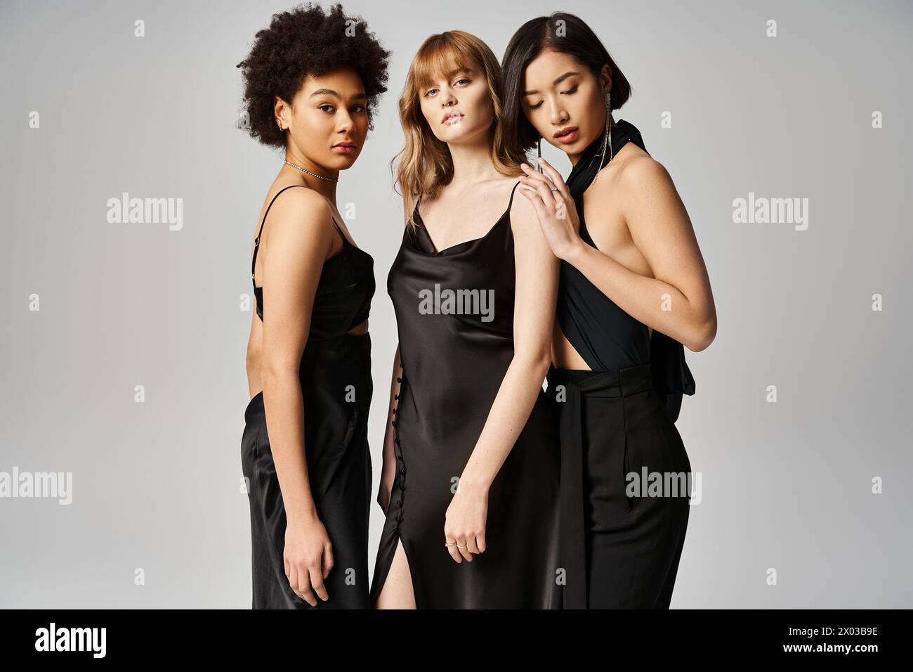Three stunning women of different ethnicities stand gracefully together ...