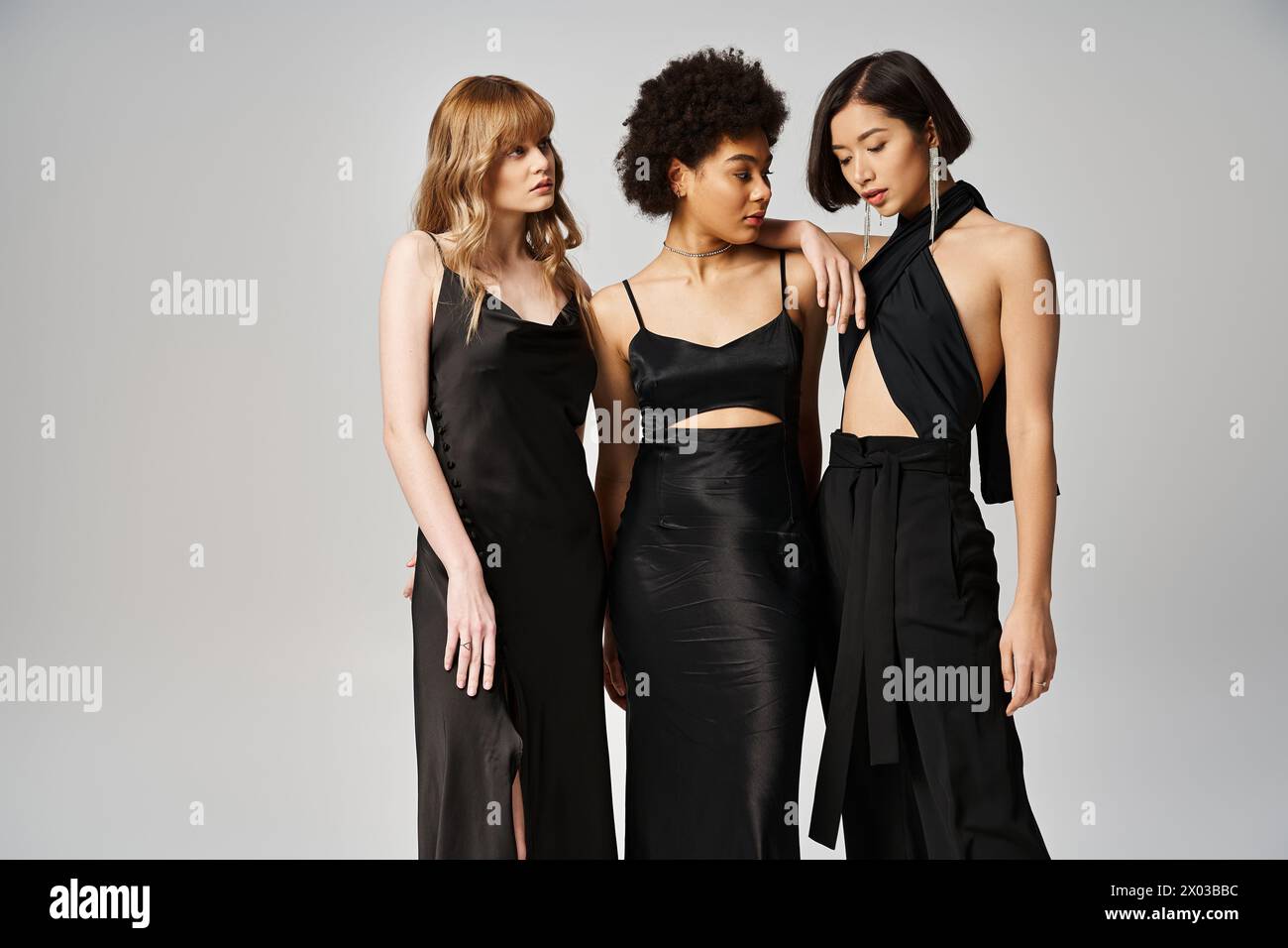 Three elegant women of Caucasian, Asian, and African American descent ...