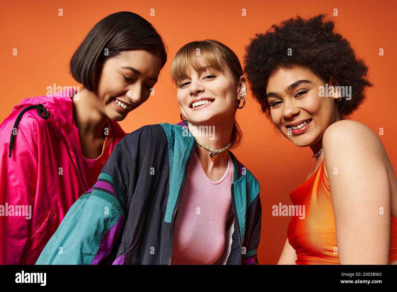 Three beautiful women of different ethnicities standing together in ...