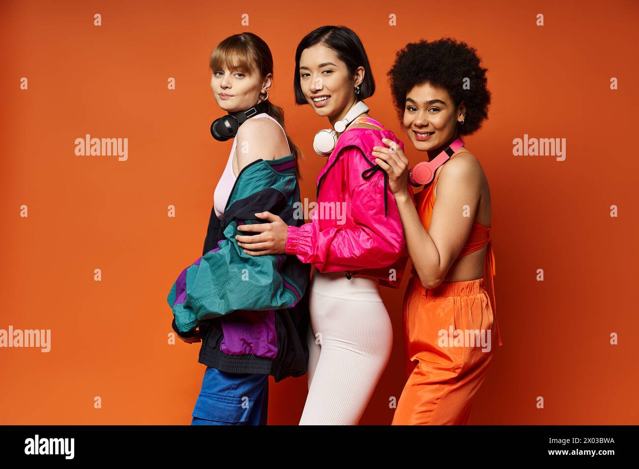 Three women of different ethnicities and styles standing together in a ...