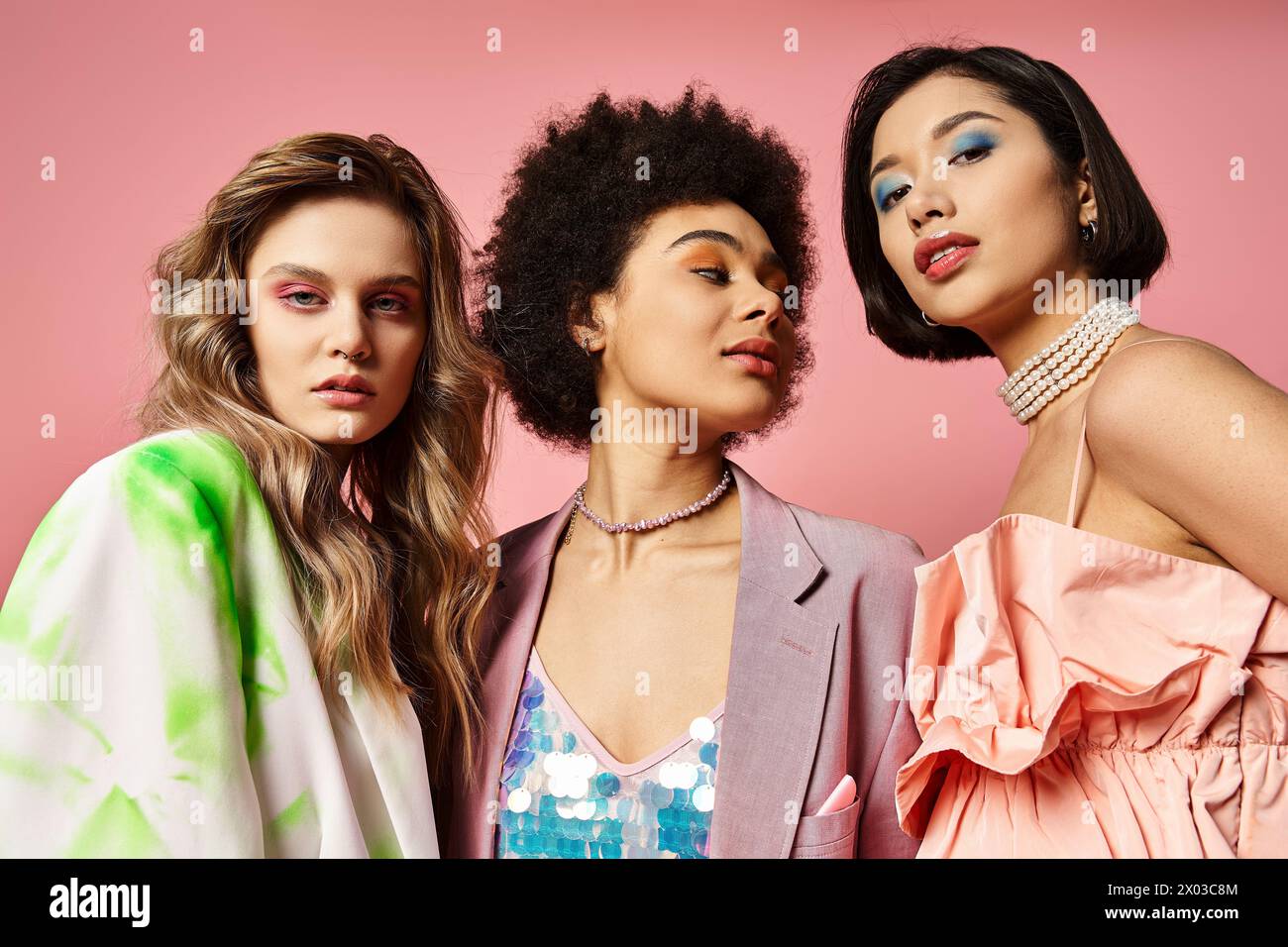 Three women of different ethnicities standing together in front of a ...