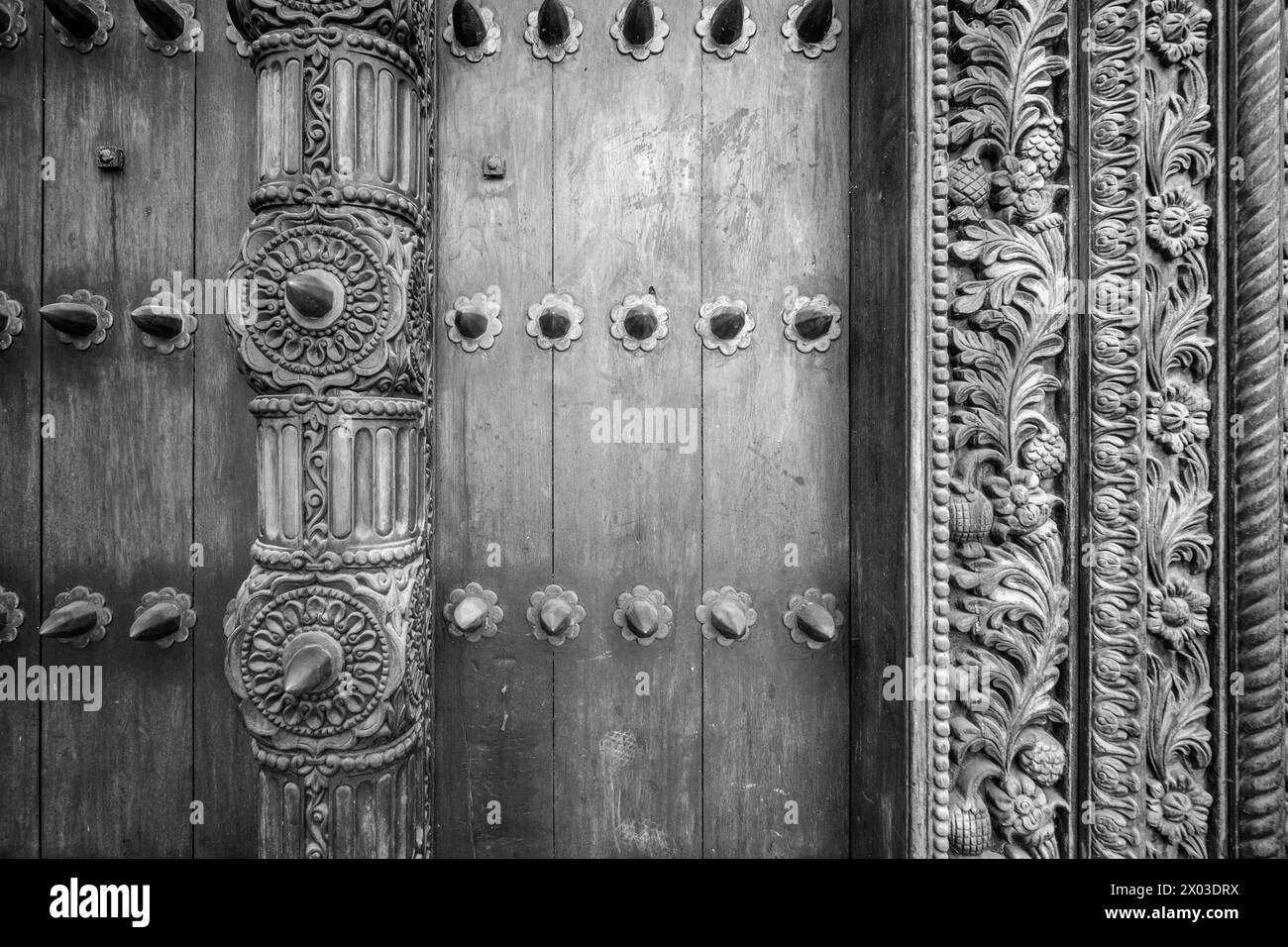 A black and white monochrome image of detail of carvings and brass ...