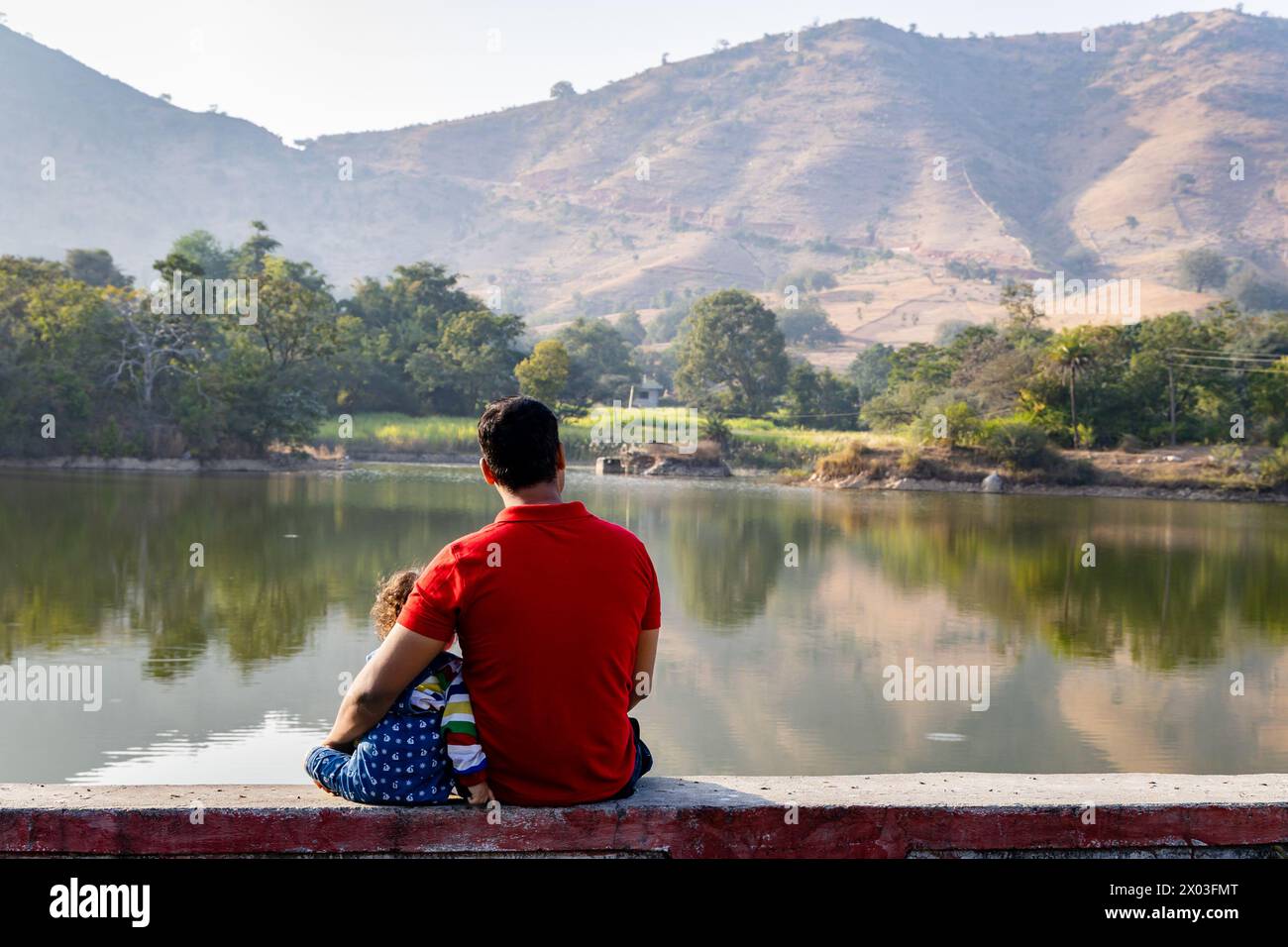 isolated young father and son enjoying nature at morning with blurred ...