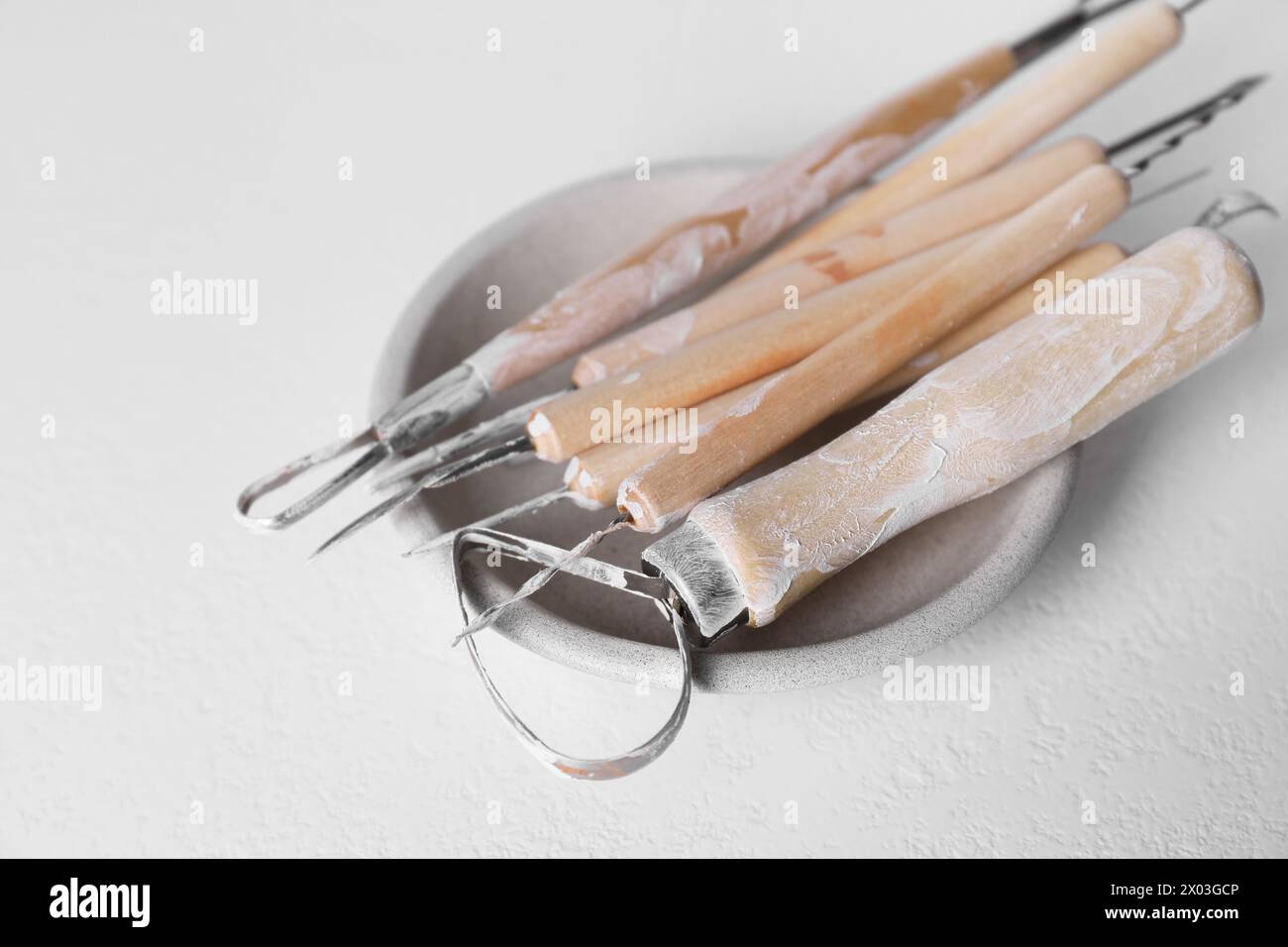 Set of different clay crafting tools on white table Stock Photo - Alamy