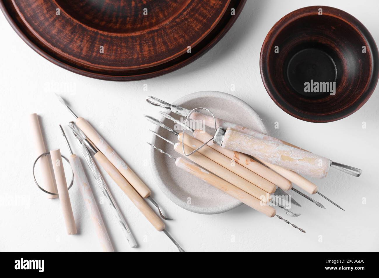 Set of different clay crafting tools on white table Stock Photo - Alamy